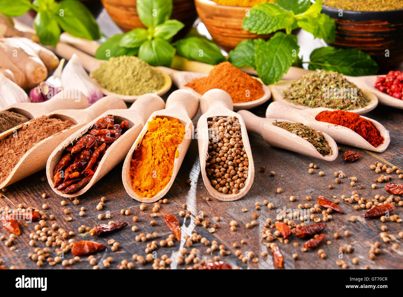Variety of spices on kitchen table Stock Photo - Alamy