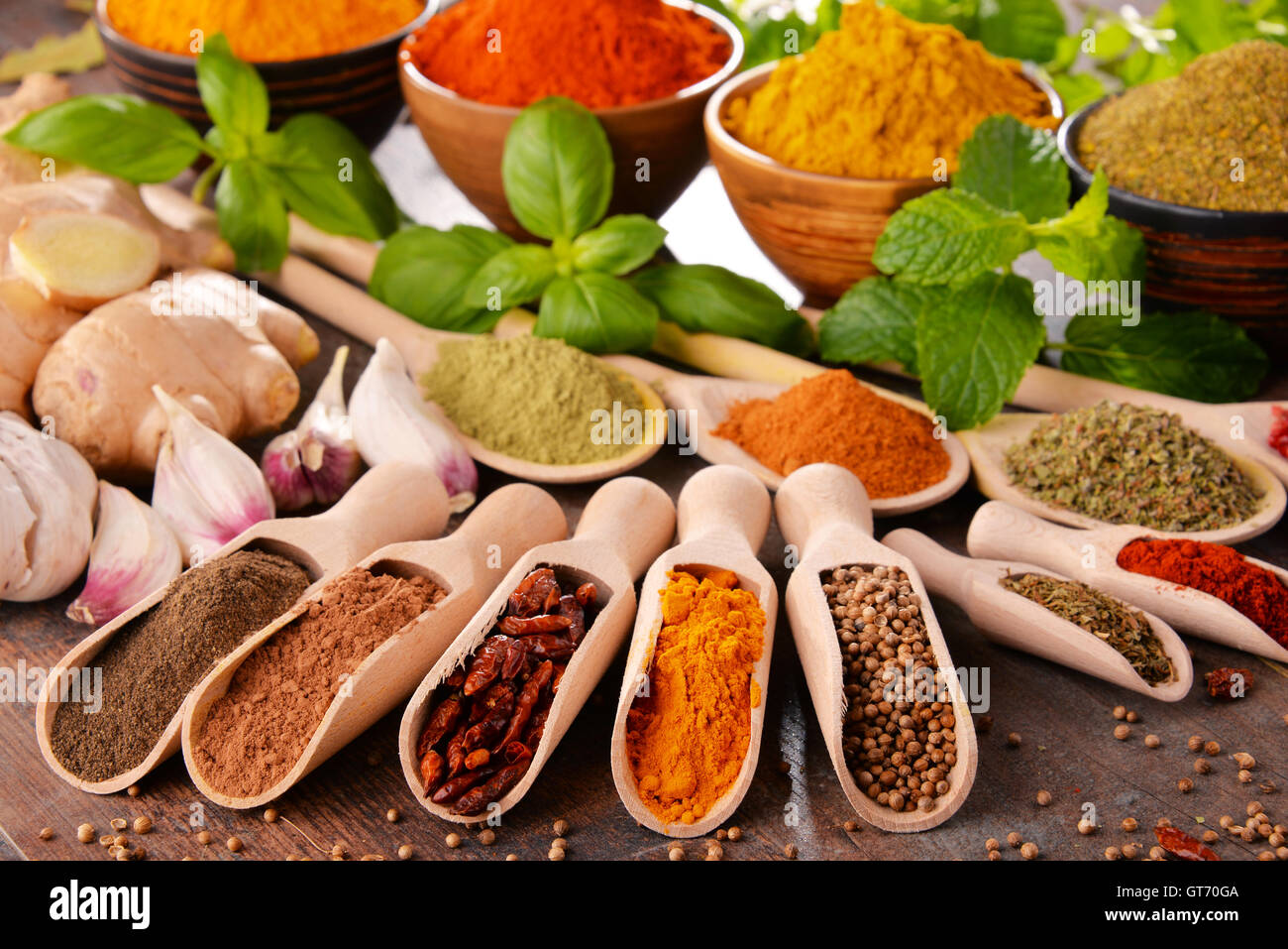 Variety of spices on kitchen table Stock Photo - Alamy