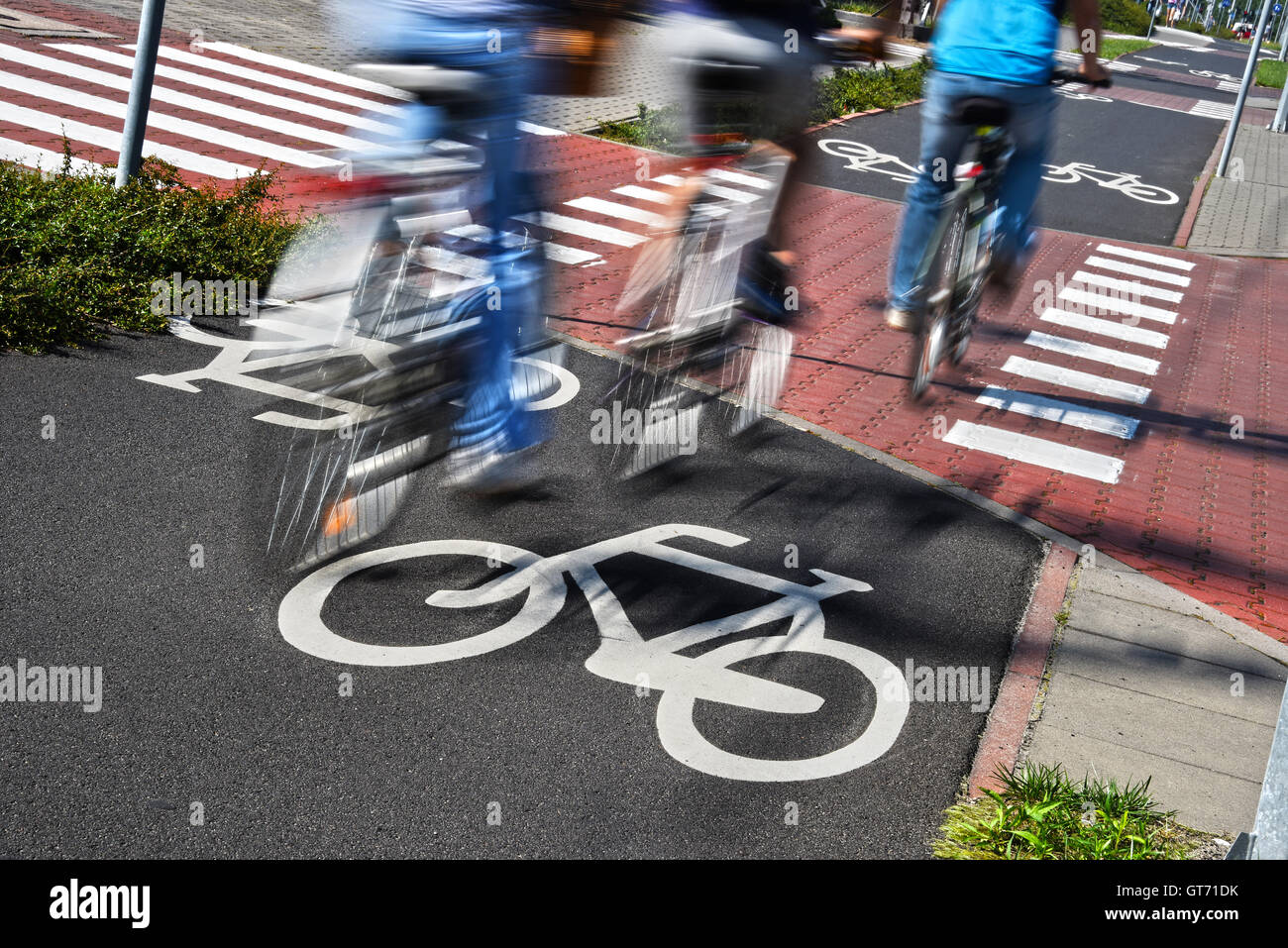 Bicycle road sign and bike riders Stock Photo - Alamy
