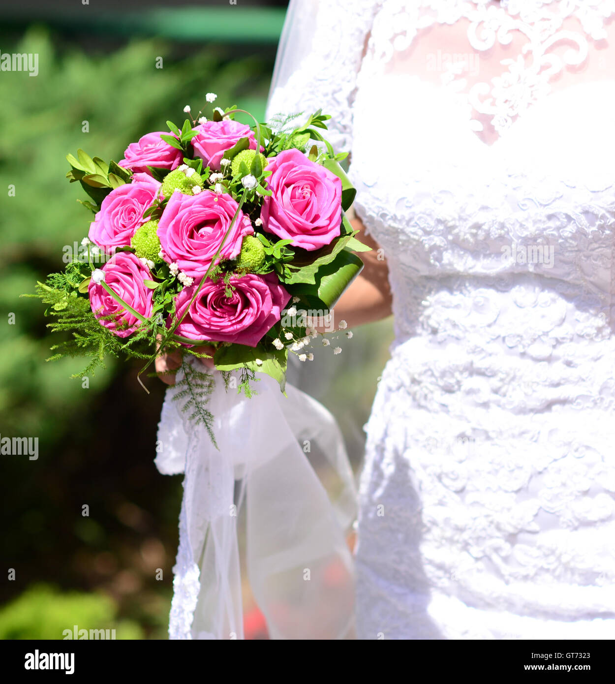 Bride holding beautiful rose bouquet Stock Photo - Alamy