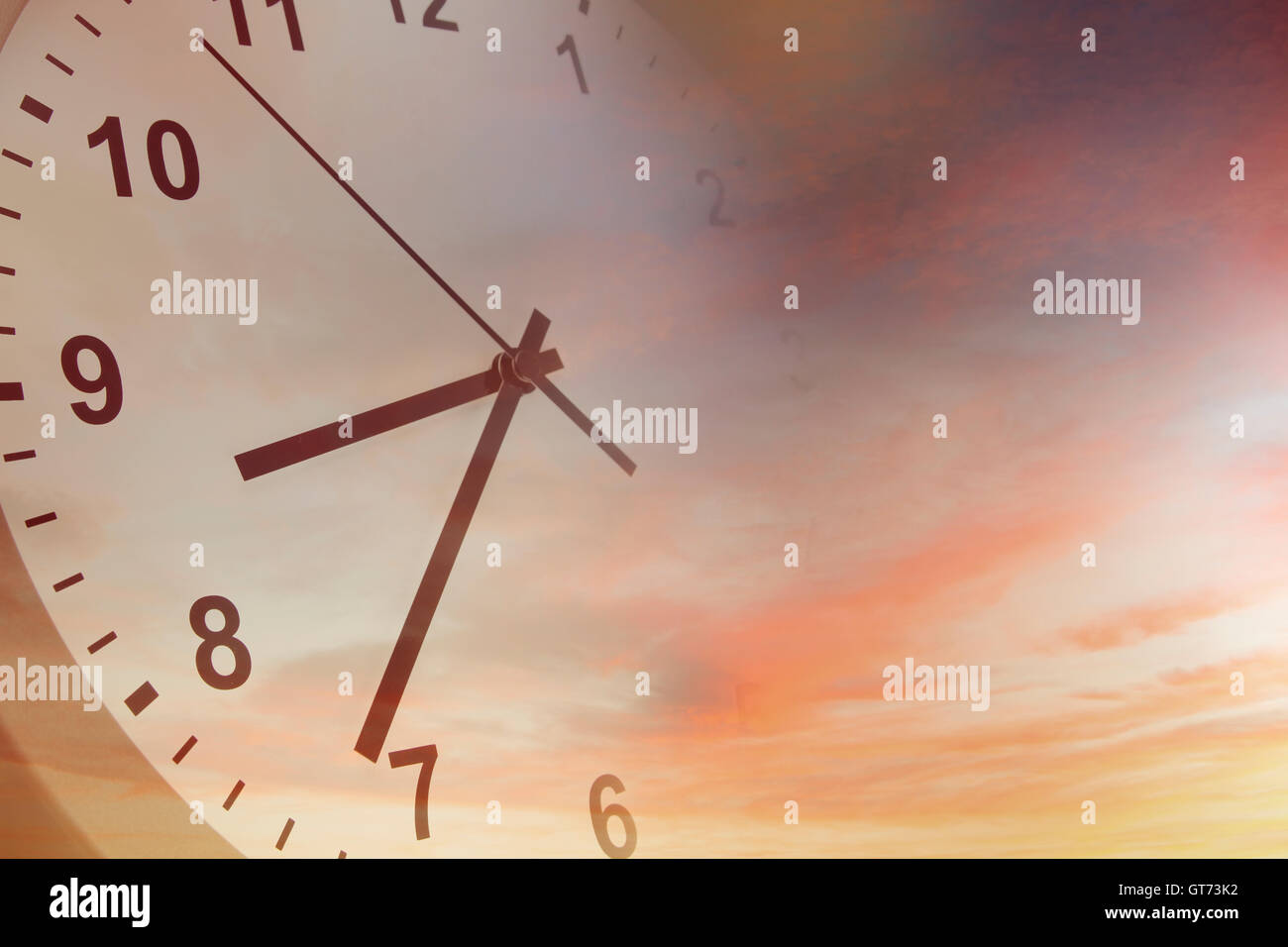 Clock face in bright sky Stock Photo - Alamy