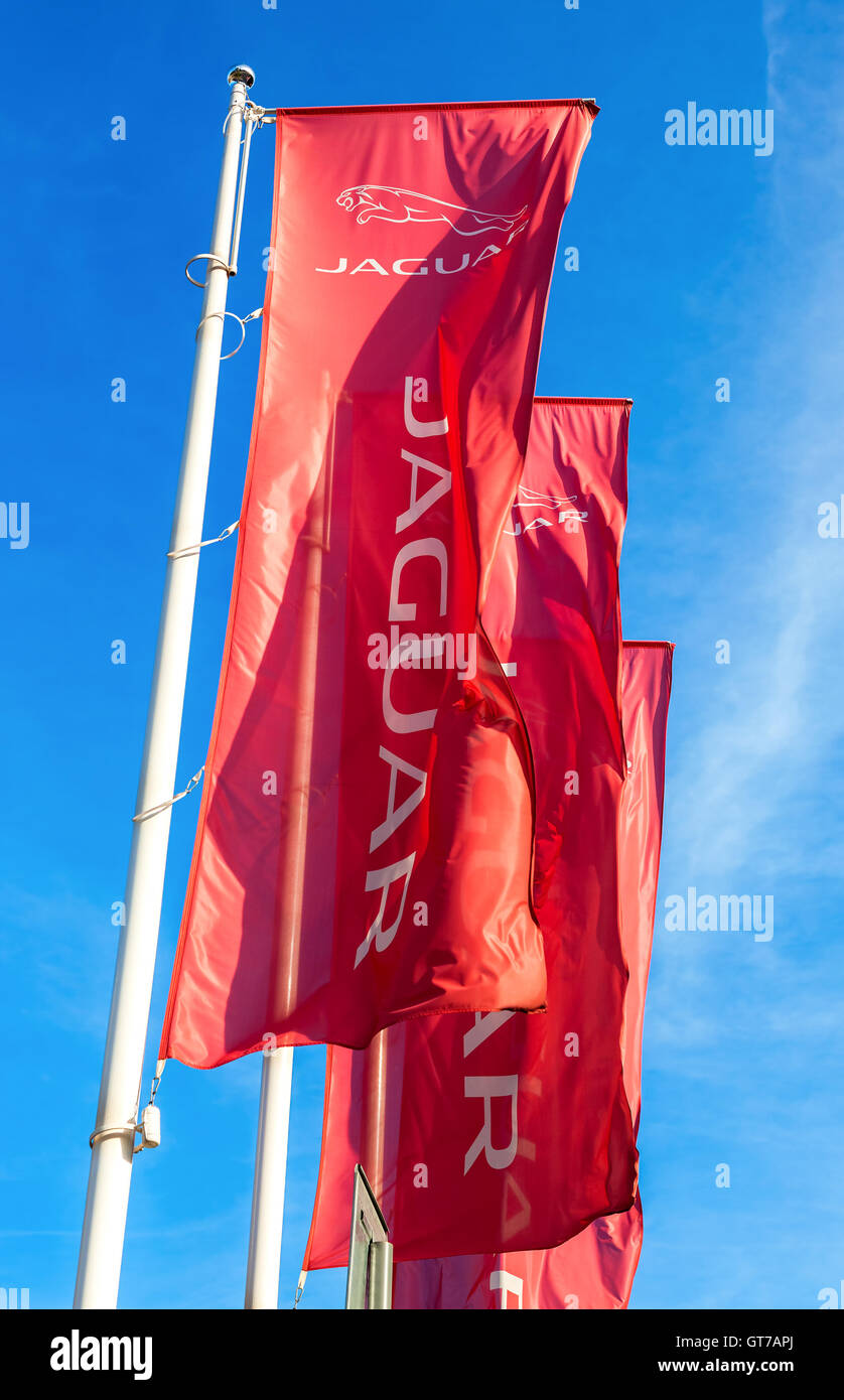 Official dealership flags of Jaguar against the blue sky background ...