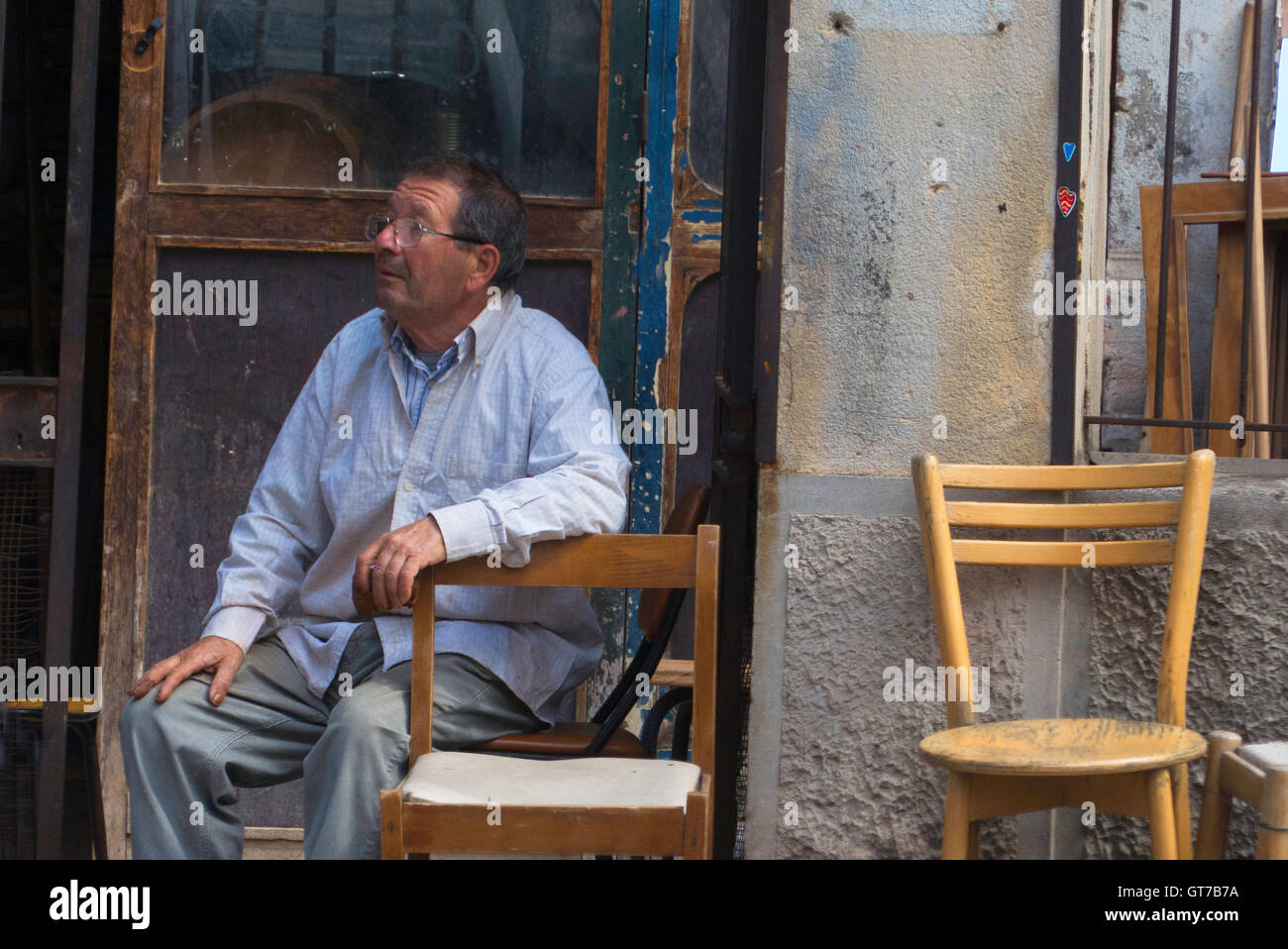 man resting on chair outside his shop Gozo,Malta Stock Photo - Alamy