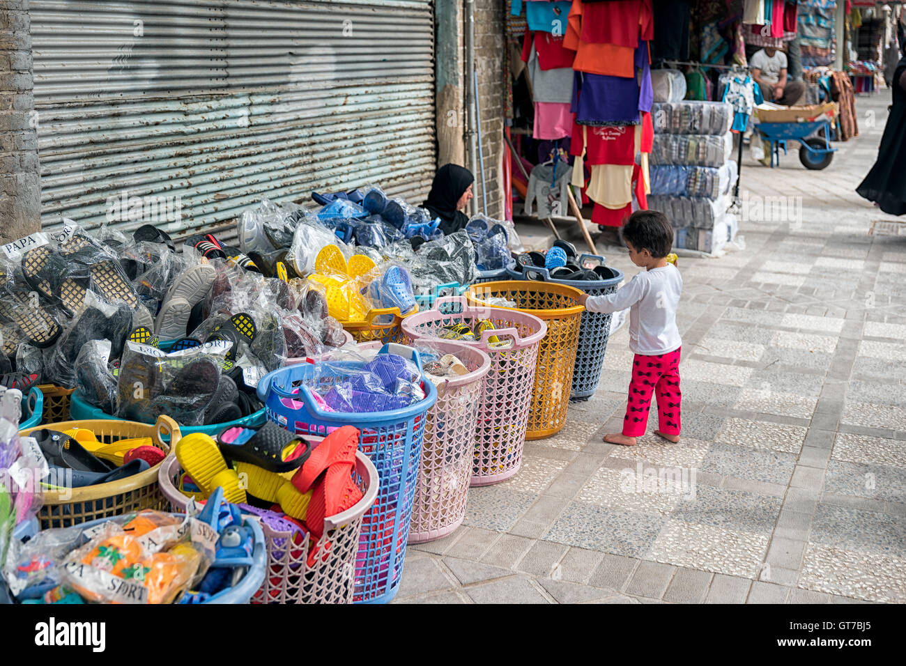Shoes for sale in baskets on the sidewalk in Yazd, Iran Stock Photo - Alamy