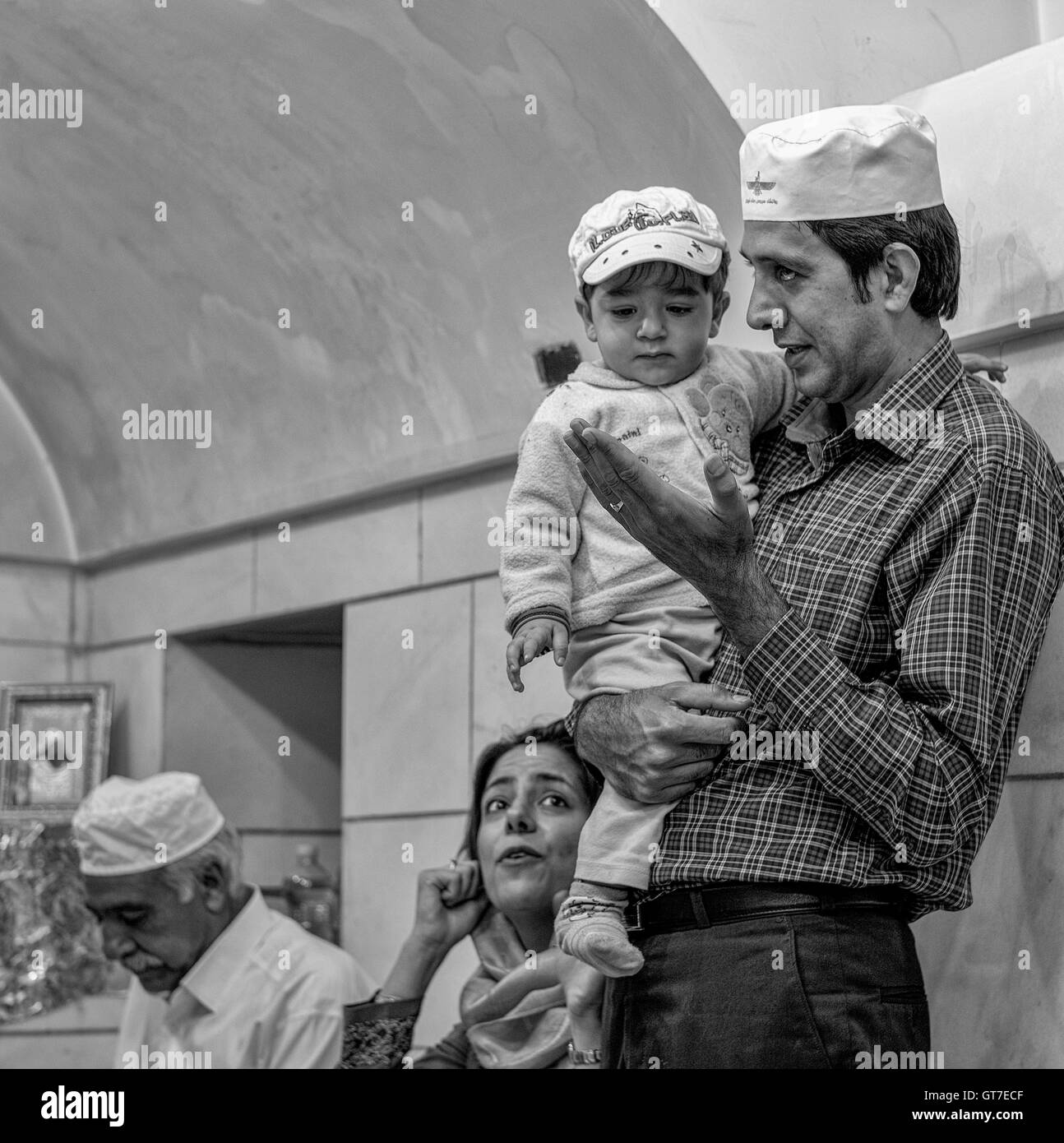 Young family worships before the Atash Bahram, meaning “Victorious Fire ...