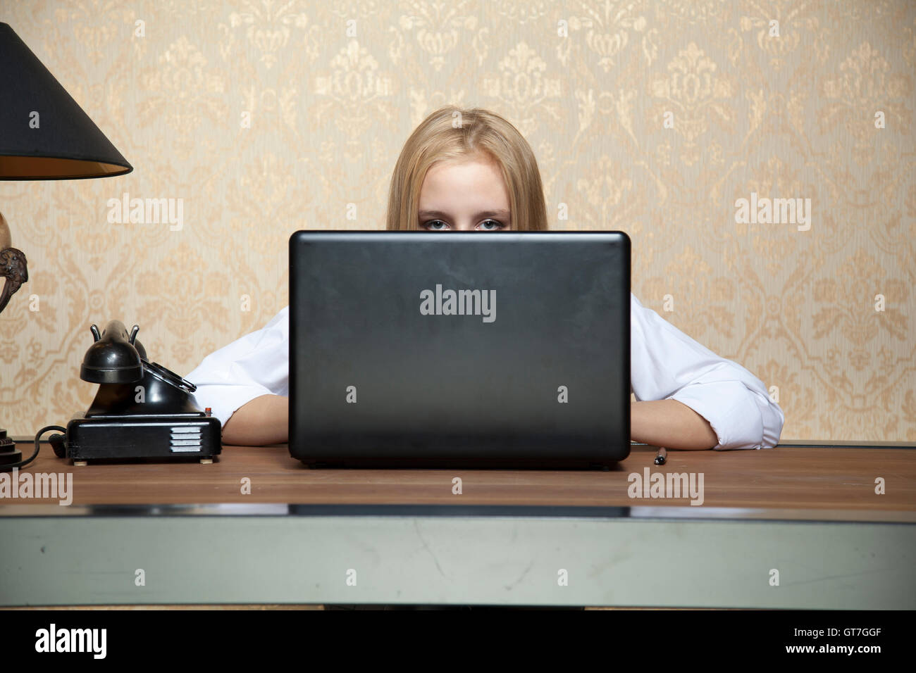 Hiding behind laptop hi-res stock photography and images - Alamy