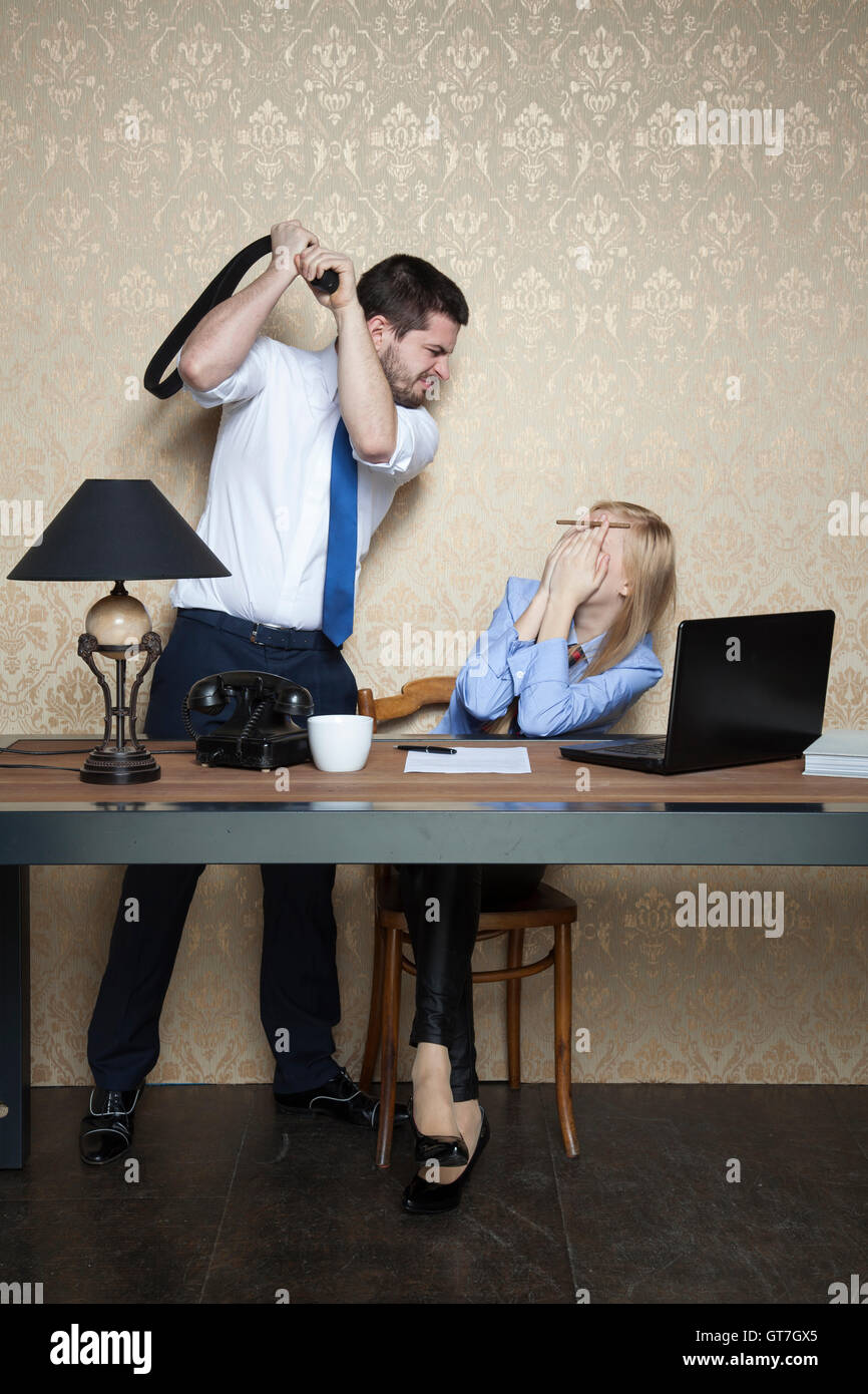 boss beats an employee for poor performance Stock Photo - Alamy