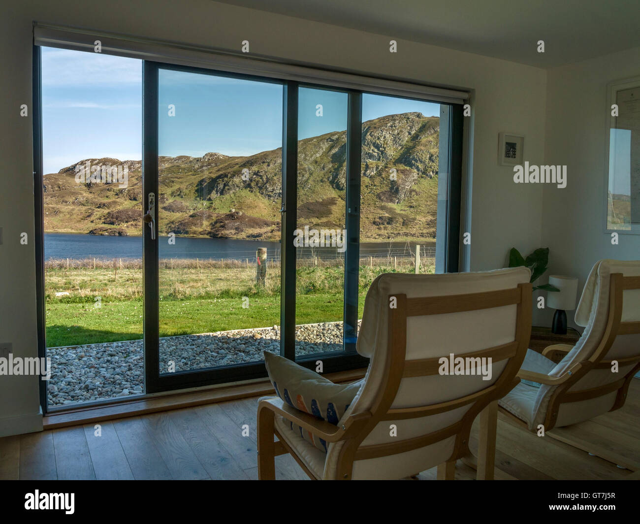Modern house living room with chairs and picture window with lovely ...