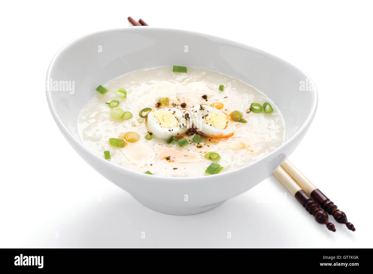 Delicious Chinese congee with chopsticks on white background Stock ...