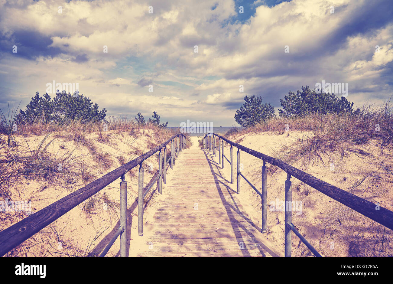 Vintage toned wooden footpath leading to a beach in a rainy day Stock ...