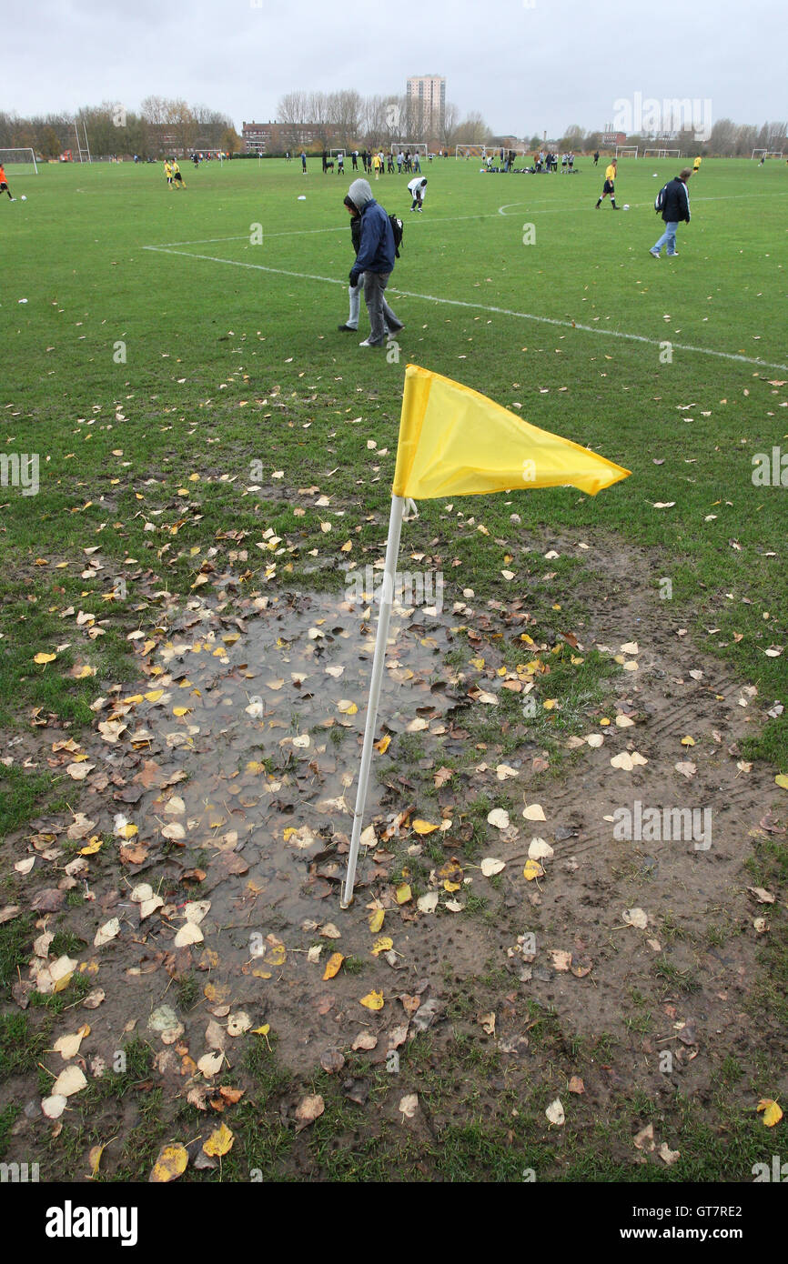 A corner flag is seen in a large puddle after heavy rain on football ...