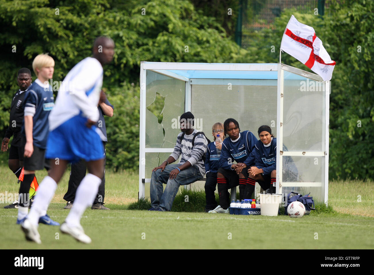 Members of New North Rangers FC look on as an England flag flies from ...