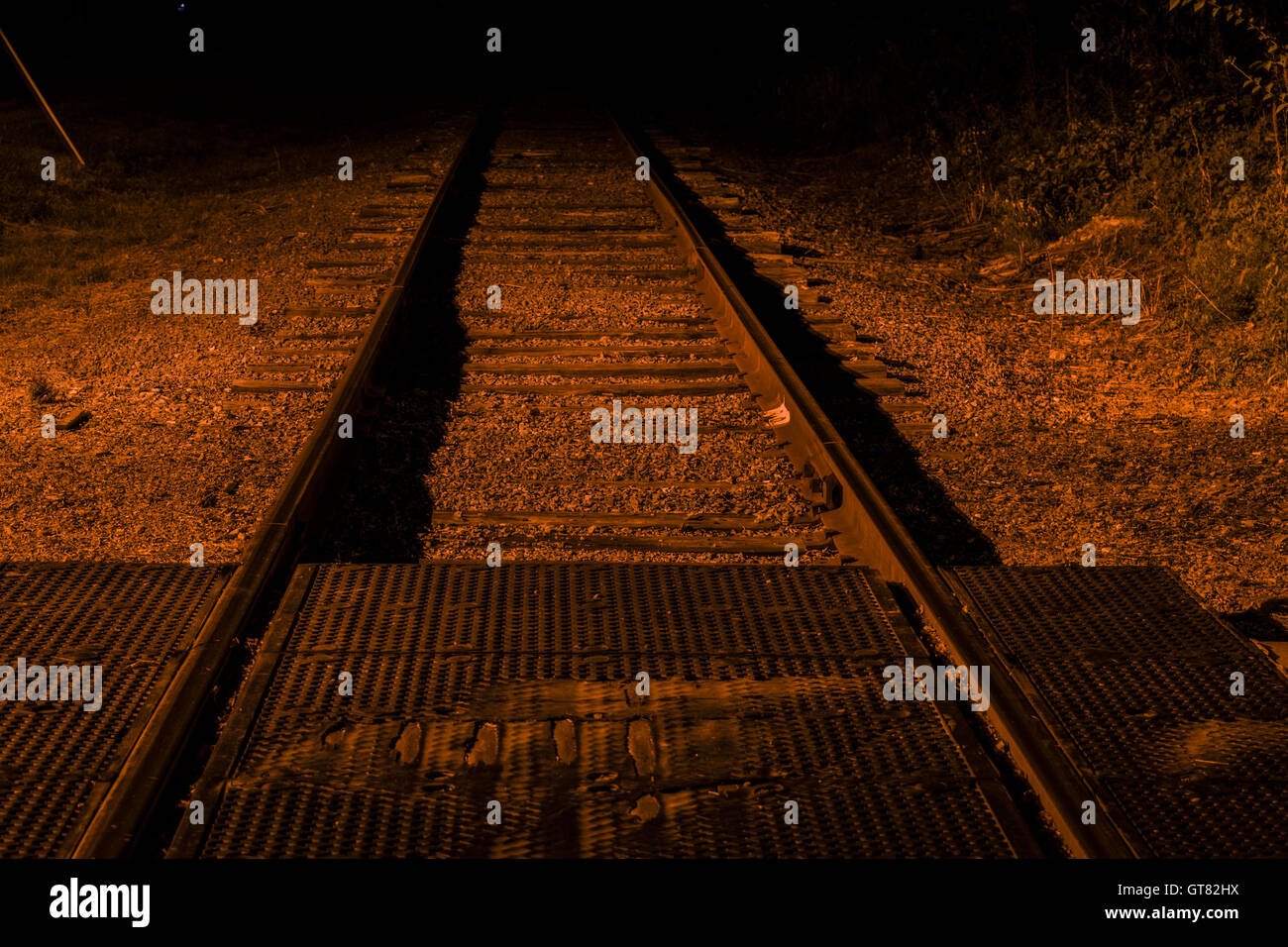 Dark railroad tracks at night Stock Photo - Alamy