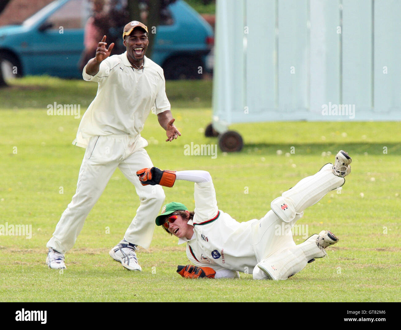 Chris Lewis (left) celebrates as Ilford wicket keeper C Bailey makes a ...