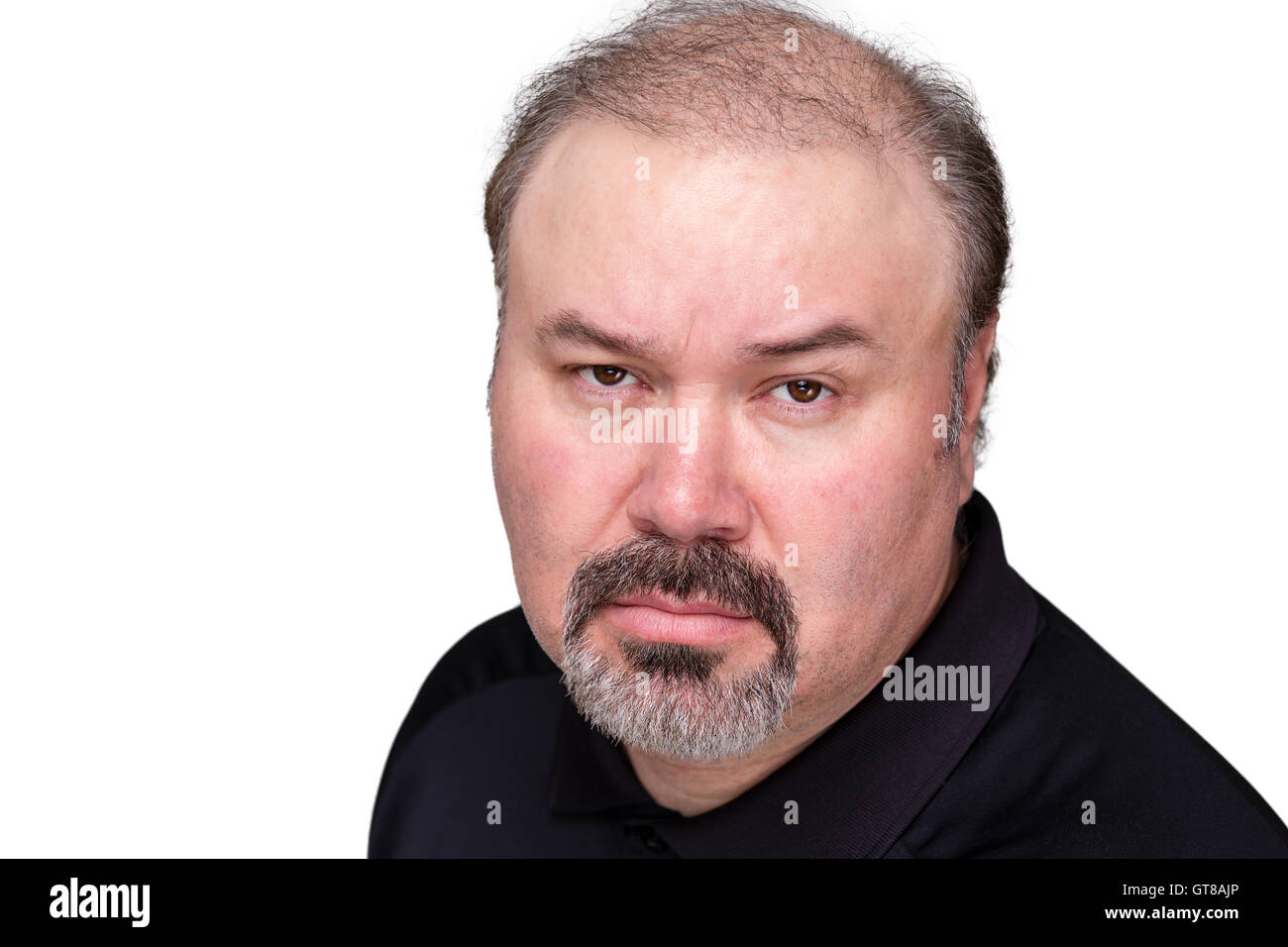 Implacable overbearing middle-aged man looking at the camera with a ...