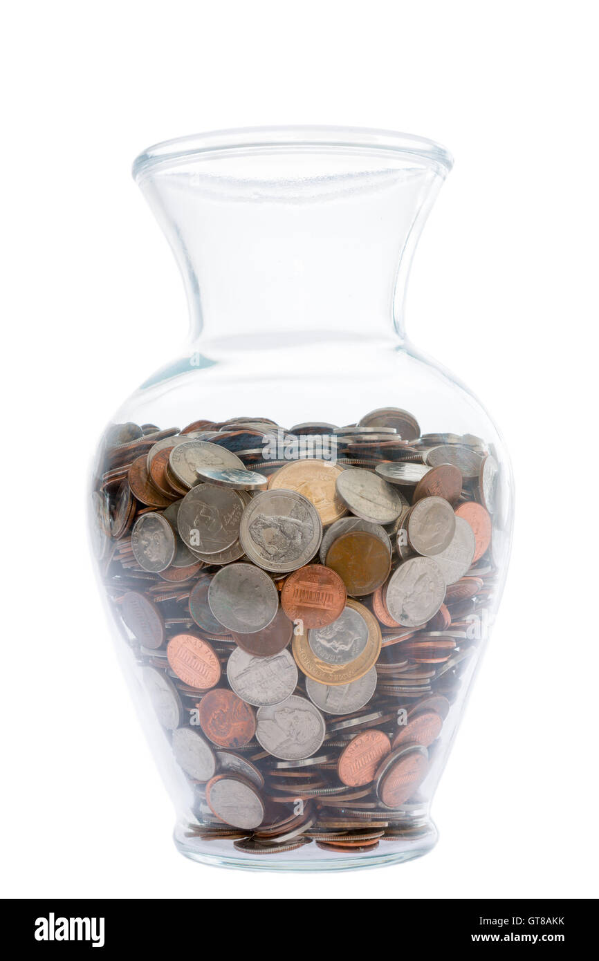 Glass vase filled with coins and small change of different ...