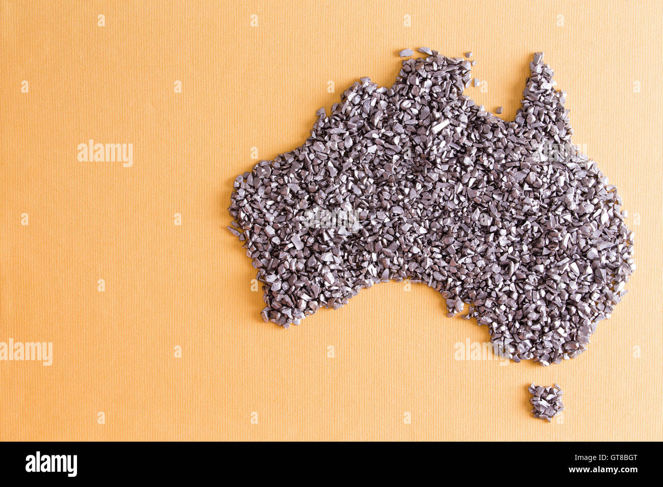 Conceptual map of Australia formed of small silvery stones on a yellow ...