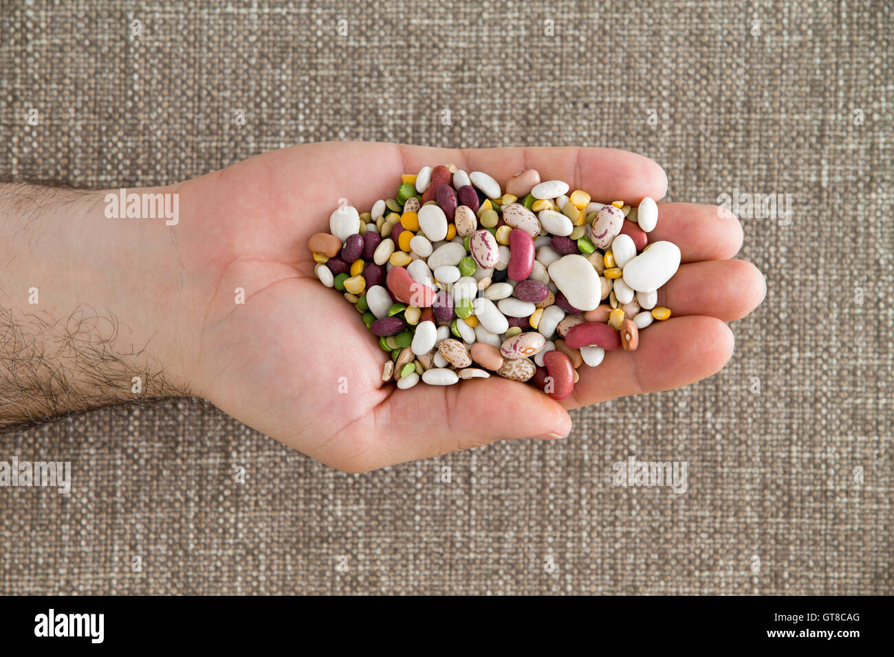 Man holding 15 assorted mixed beans and legumes in his hand including ...