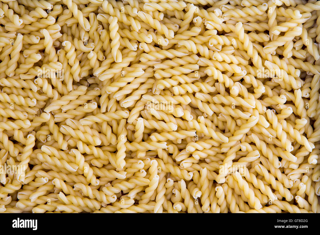 Background texture of dried organic gemelli pasta meaning twins, formed ...