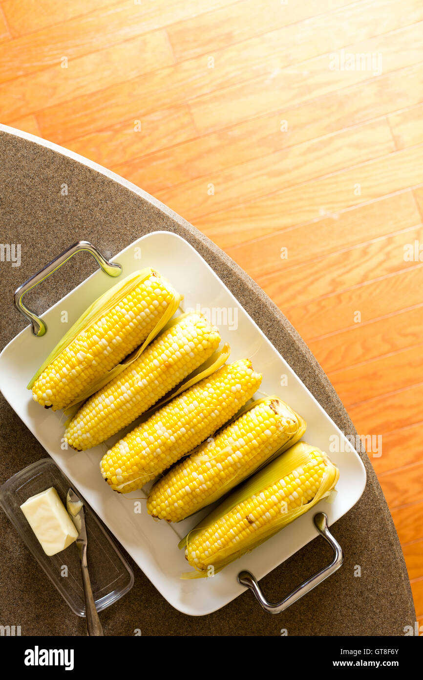 Delicious tray of cooked corncobs or sweet corn served with salt and ...