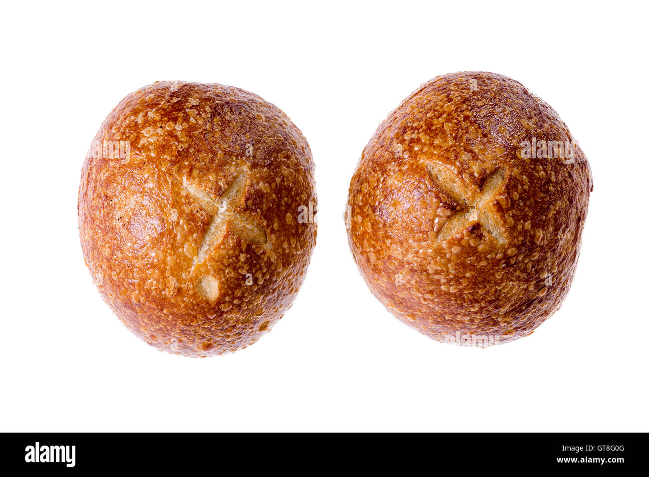 Two crusty round fresh sourdough rolls or buns decorated with crosses ...