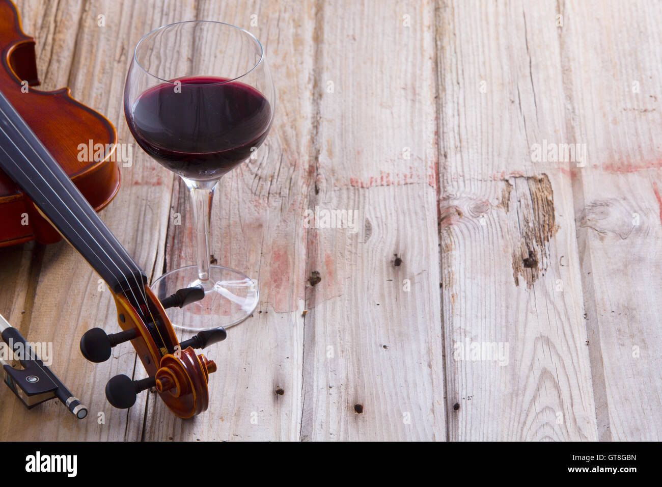 Pair of Violin Instrument and Glass of Wine Wine on a Wooden Floor with ...