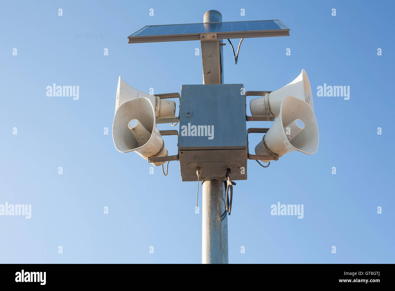 Solar-powered megaphones pole against blue sky background Stock Photo ...