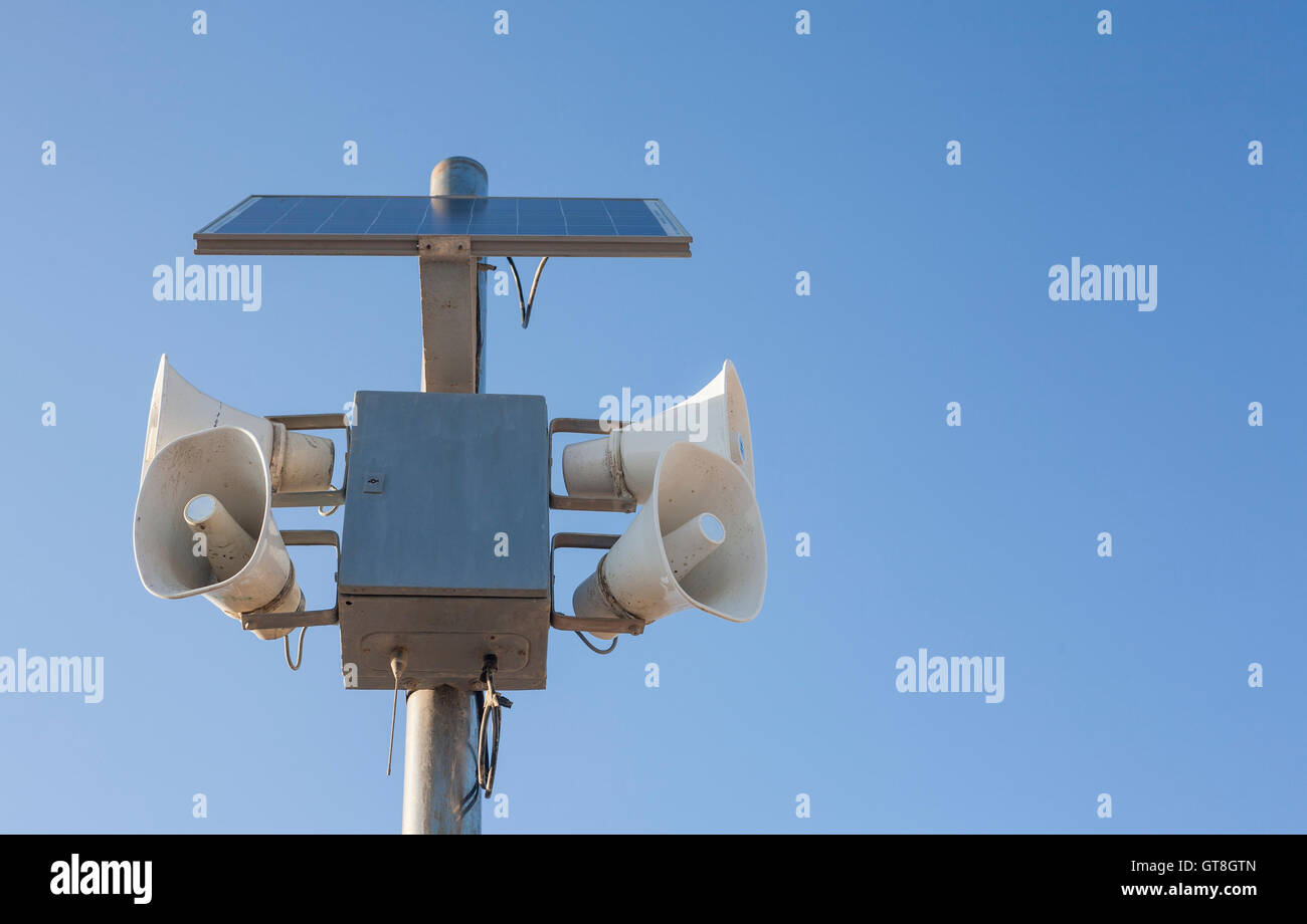 Solar-powered megaphones pole against blue sky background Stock Photo ...