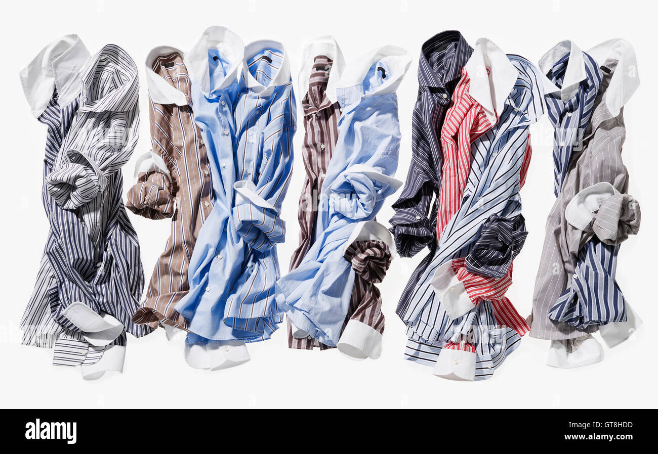 Group of multi coloured shirts on white background Stock Photo - Alamy