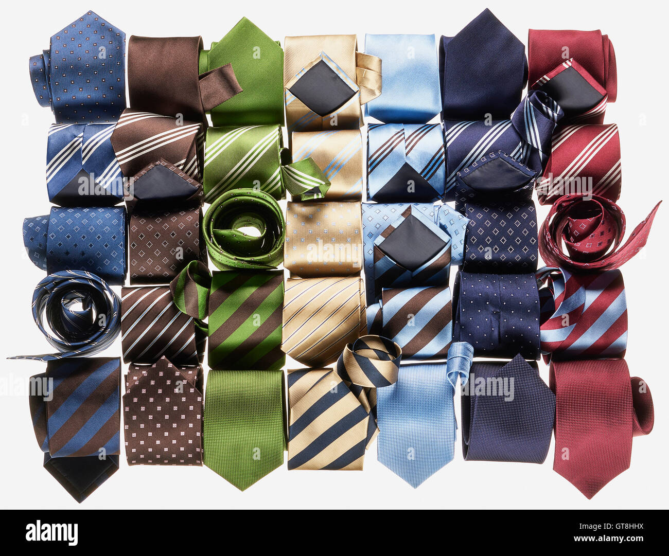 Group of multi coloured neckties roled-up on white background Stock ...