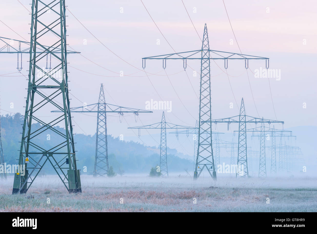 Electricity Pylons in Morning Mist, Hesse, Germany Stock Photo - Alamy
