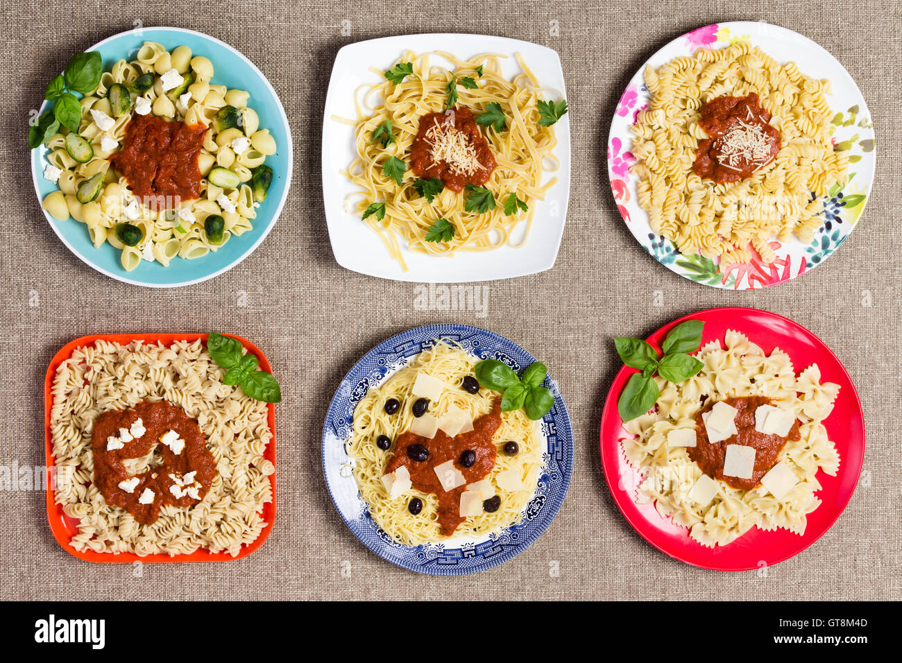 Six square and circular plates filled with various types of pasta ...
