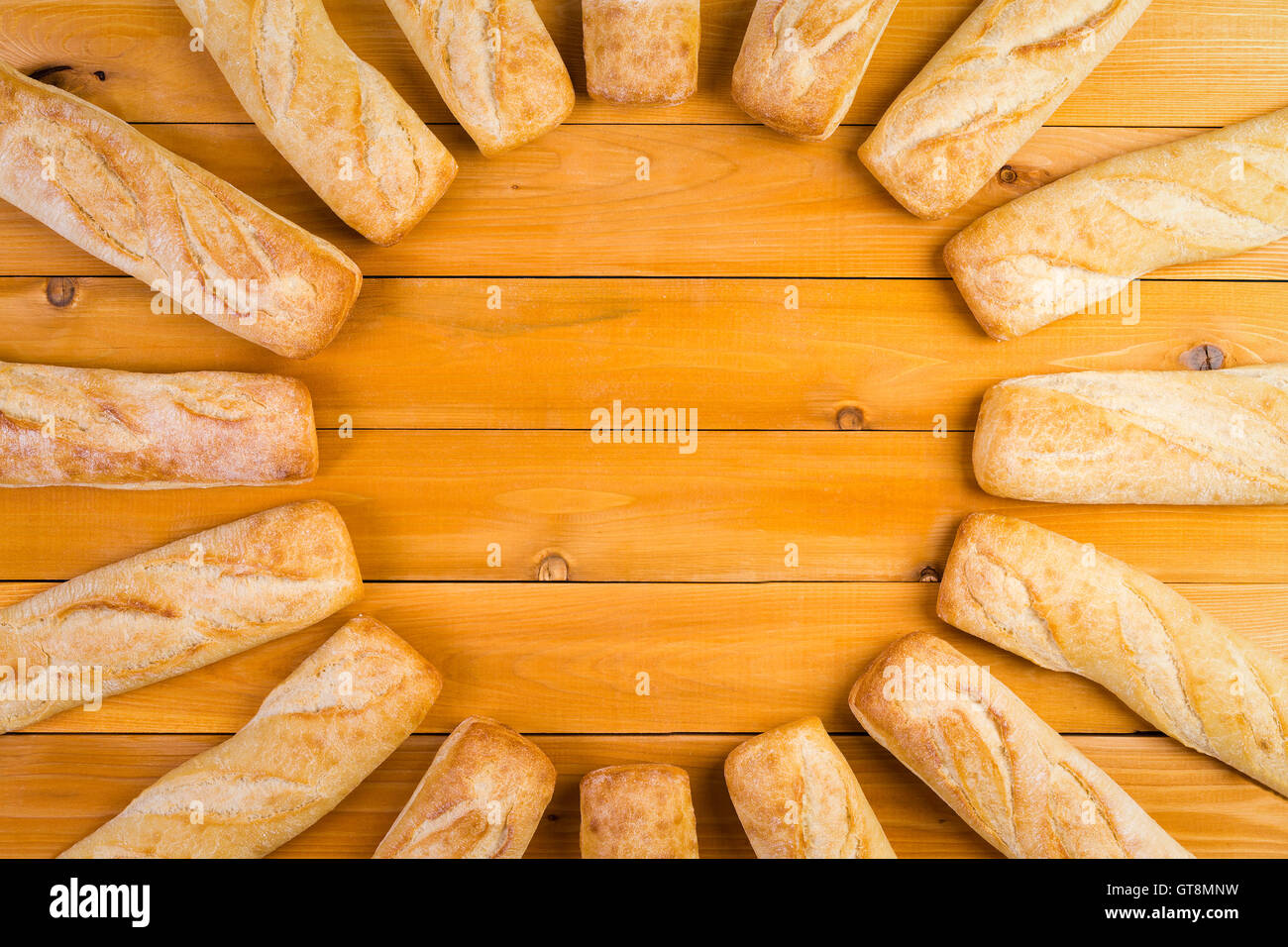 Circular frame of freshly baked crusty French bread loaves arranged in ...