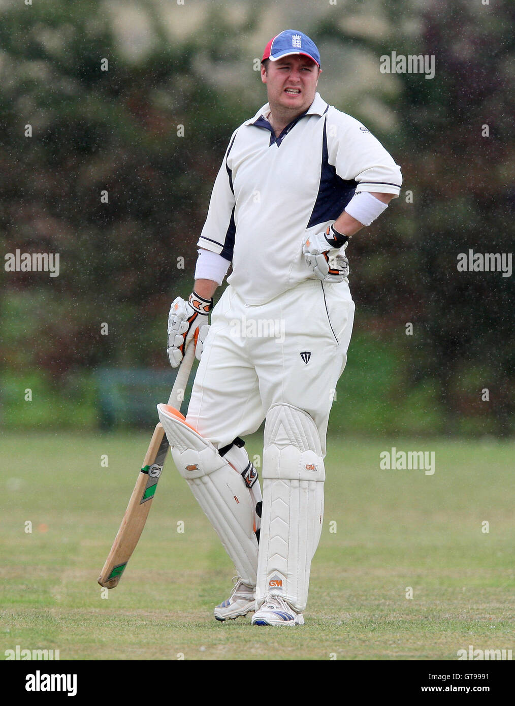 Rainham captain Alex Sullivan considers the weather conditions as rain falls - Rainham CC vs ...