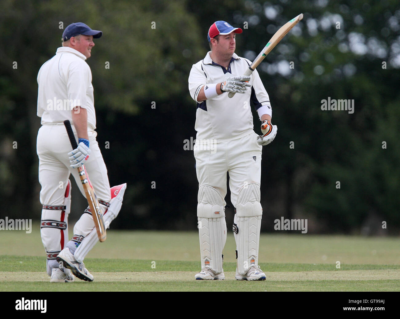 Alex Sullivan of Rainham (R) acknowledges 50 runs for his team ...