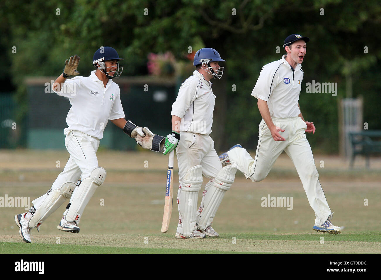 Steve Mack of Upminster (C) is clean bowled and Wanstead celebrate ...