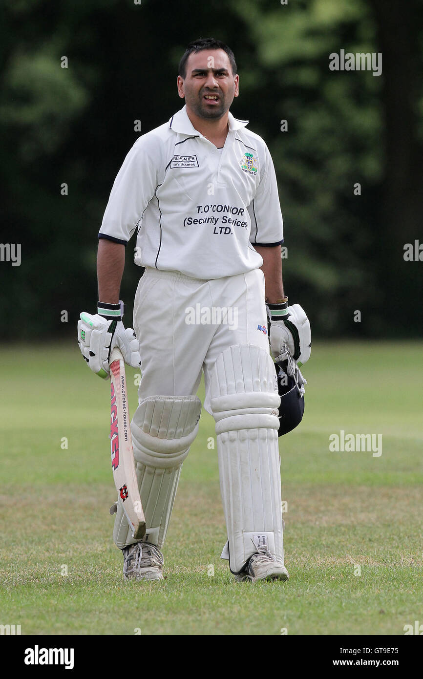 Adnan Akram of Wanstead leaves the field after being dismissed ...