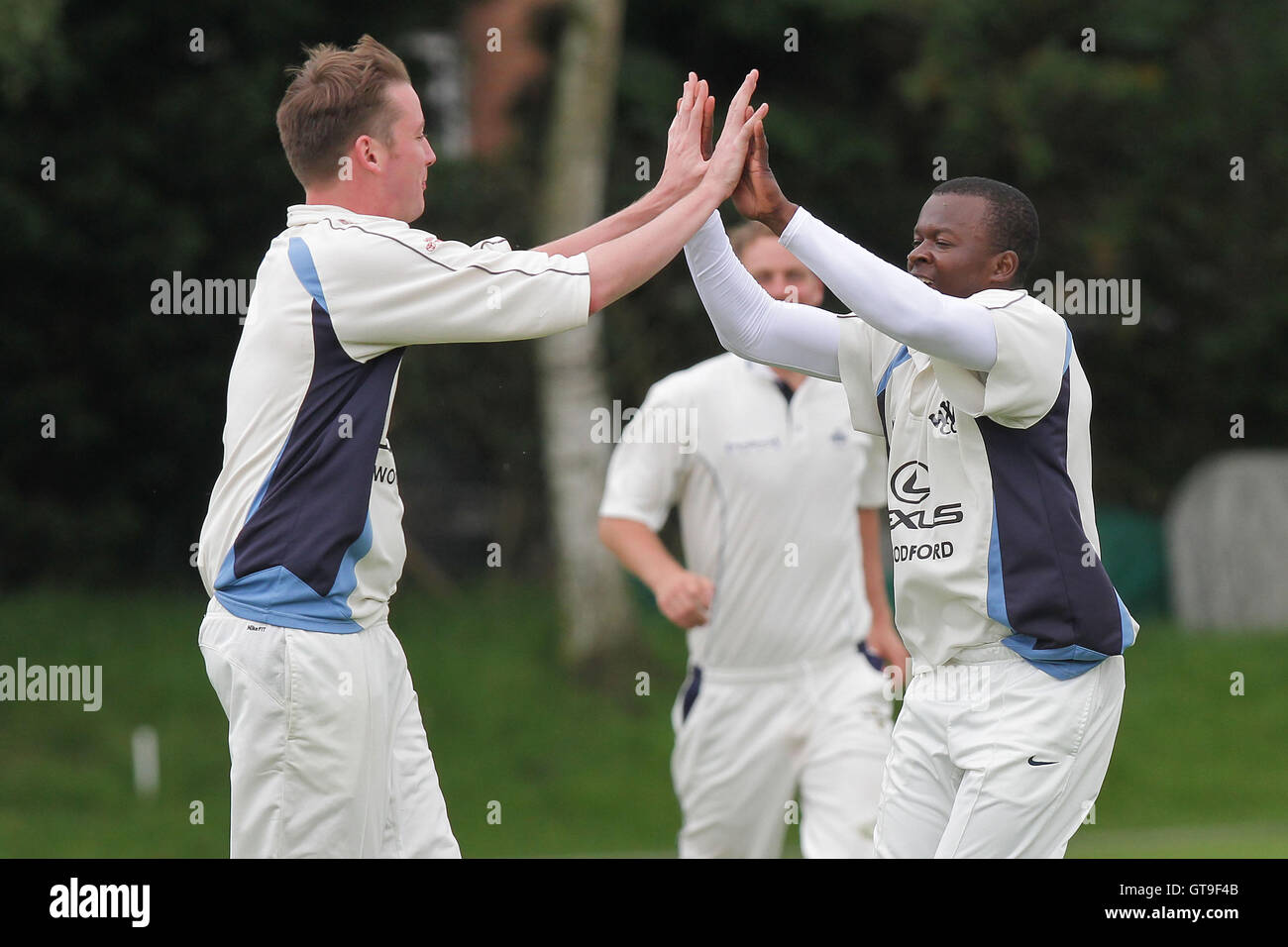 Donovan Miller of Woodford Wells (R) celebrates the wicket of Sayed ...
