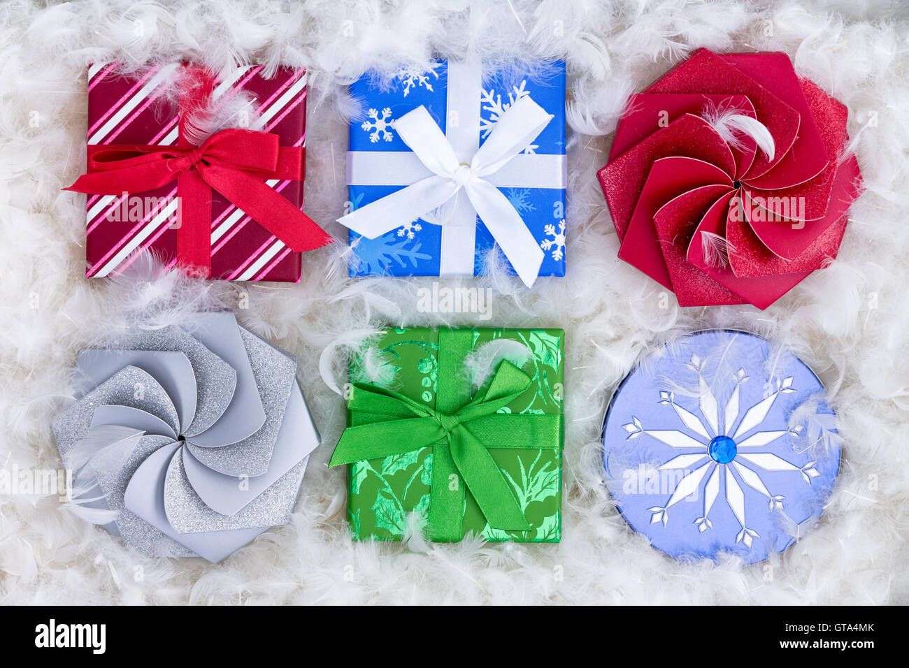 Top down view on six Christmas gift boxes surrounded by fluffy padding ...