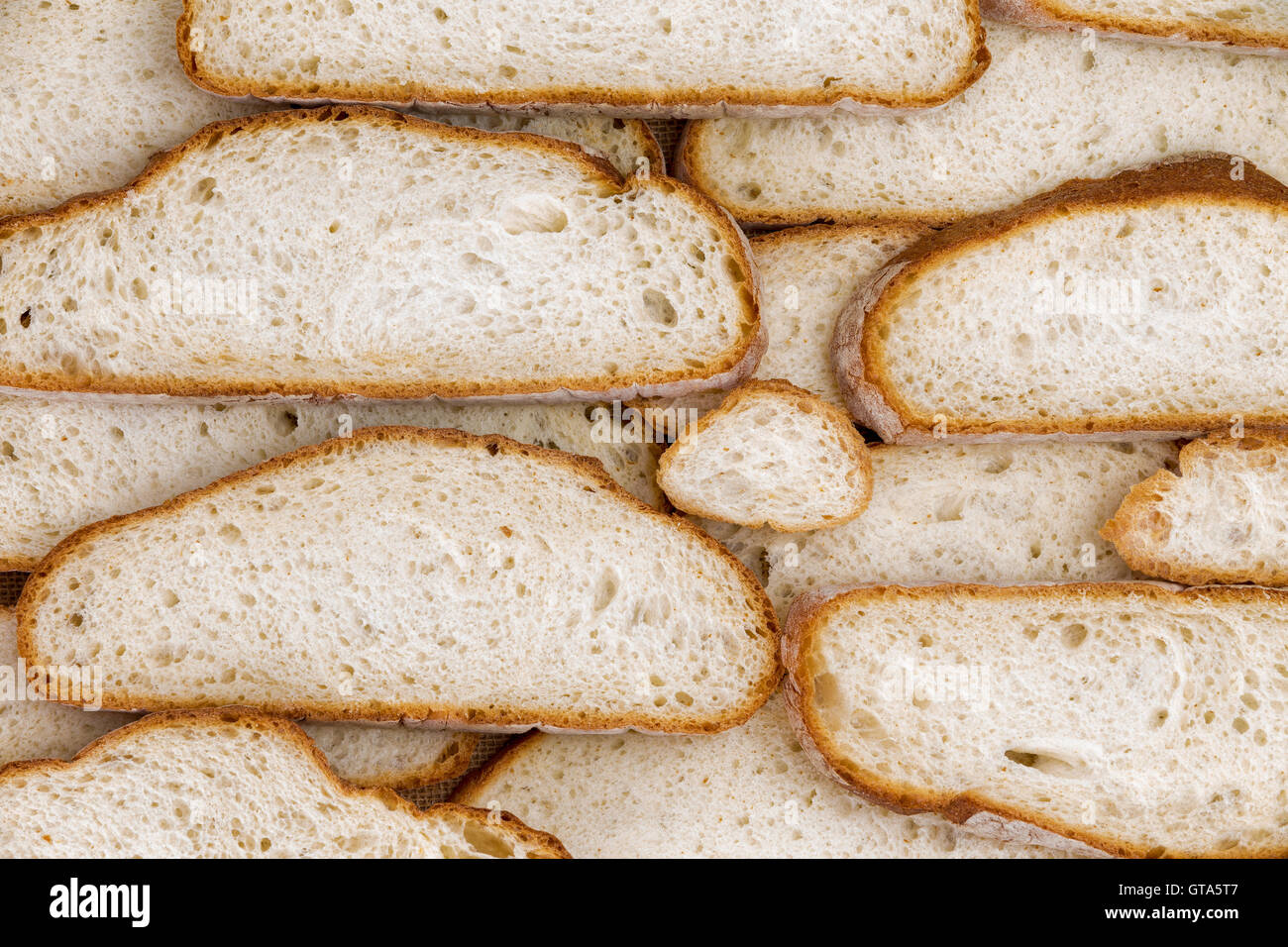 Wall of home made various sized bread slices as background for concept ...