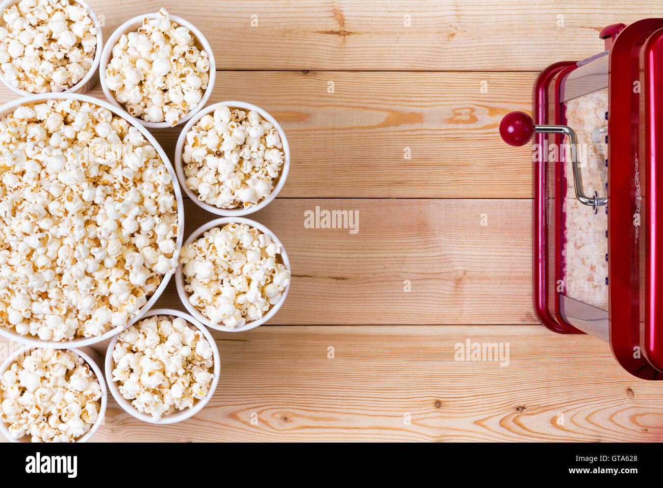 Dishes of fresh popcorn arranged in a decorative circle around a larger ...