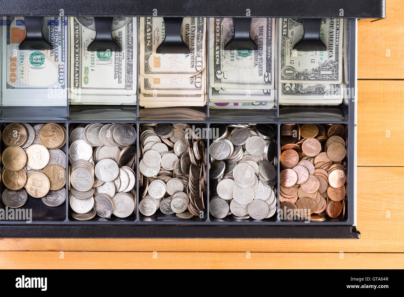 Top down view on single cash register drawer stocked full with pennies ...