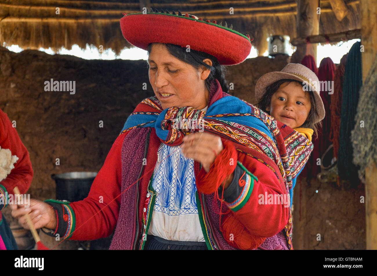 Native woman dressed in traditional colourful clothing explaining the ...