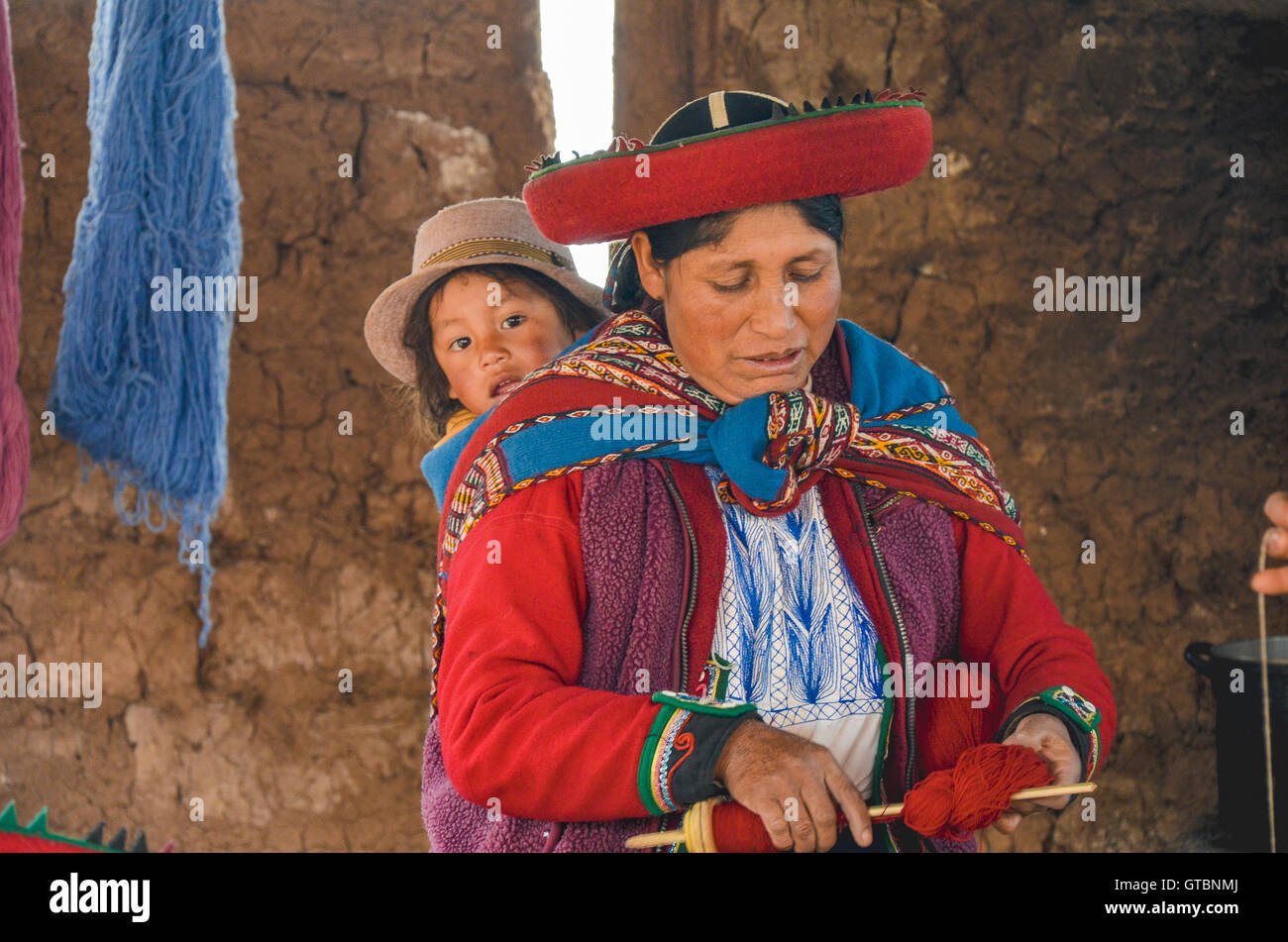 Native woman dressed in traditional colourful clothing explaining the ...