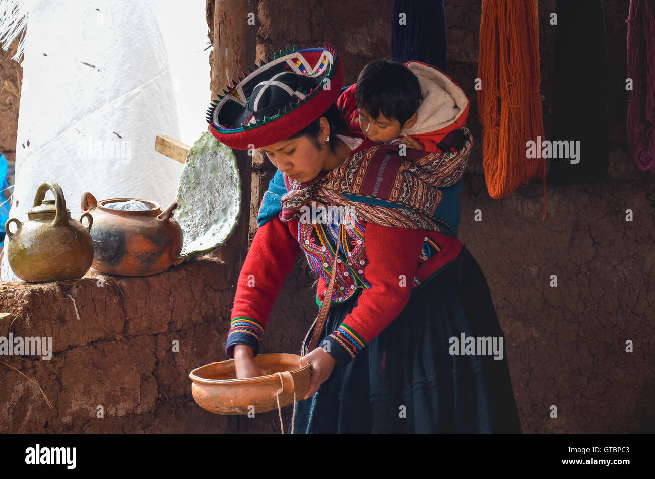 Native woman dressed in traditional colourful clothing explaining the ...