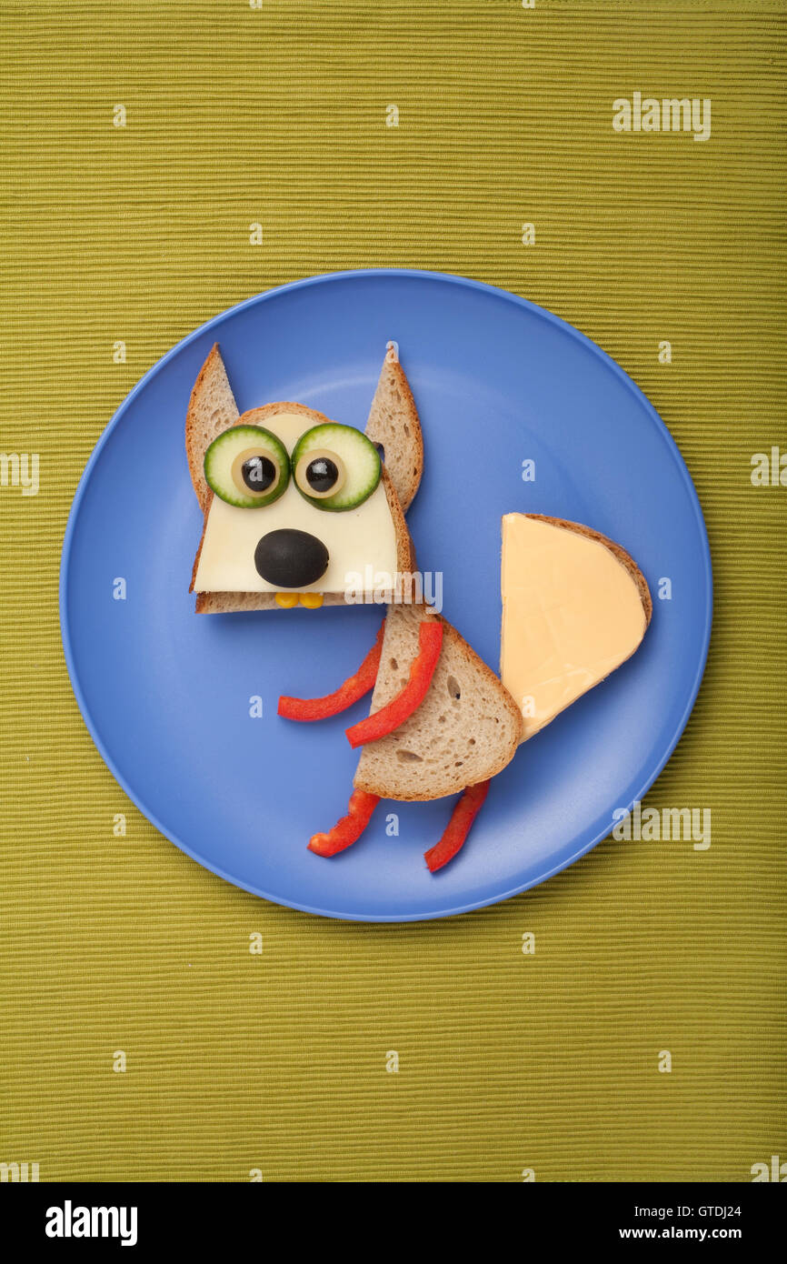 Squirrel made of bread and vegetables on plate and fabric Stock Photo ...