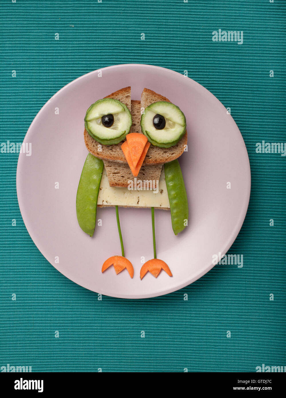 Owl made of bread, cheese and vegetables on plate and fabric Stock ...