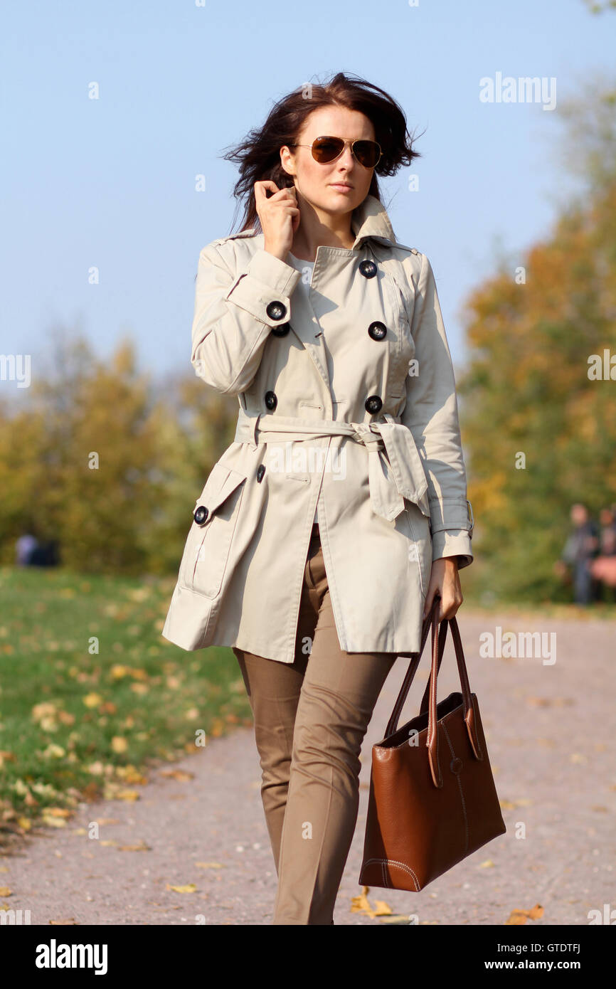 Full length, walking woman in autumn park Stock Photo - Alamy