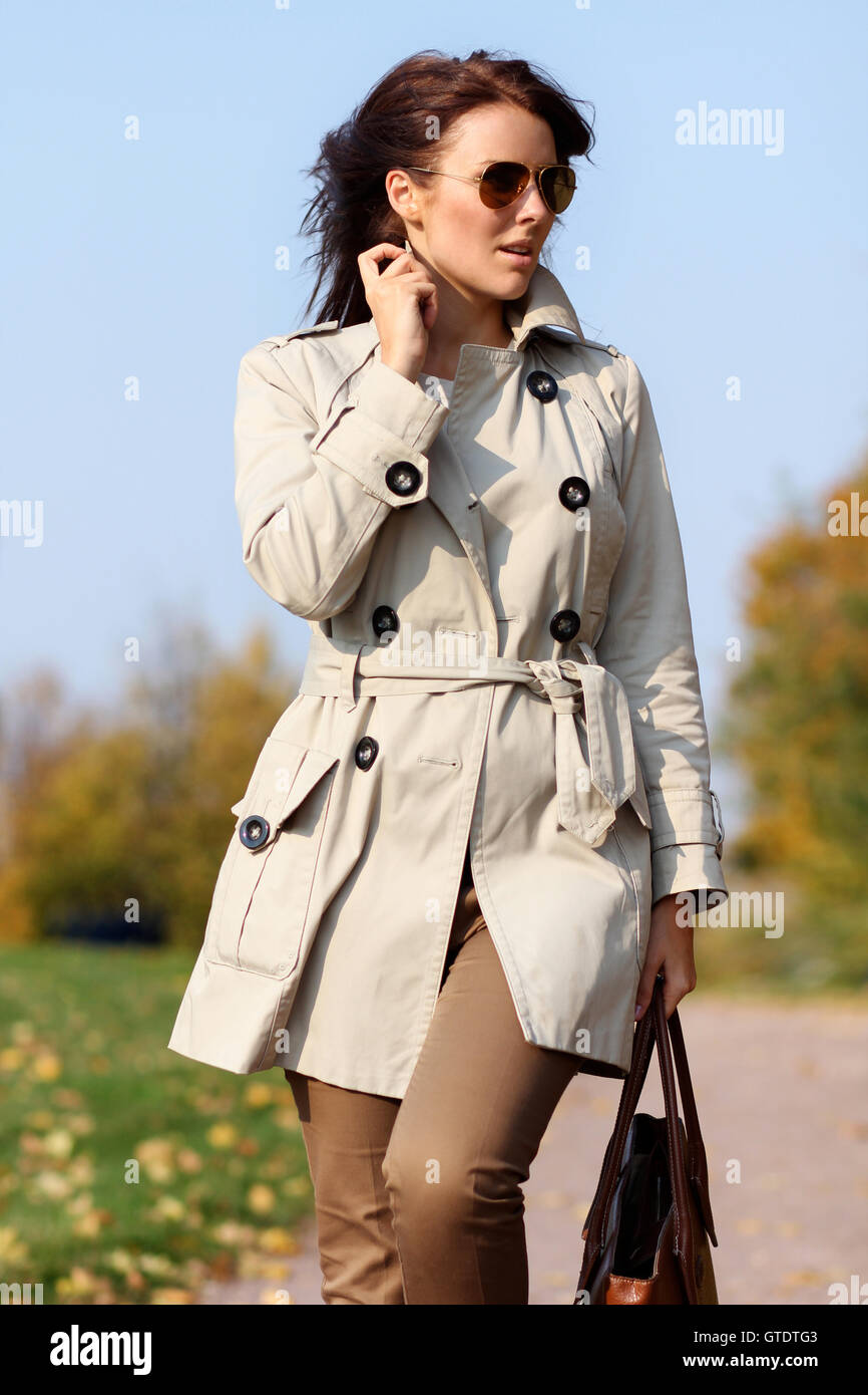 Full length, walking woman in autumn park Stock Photo - Alamy