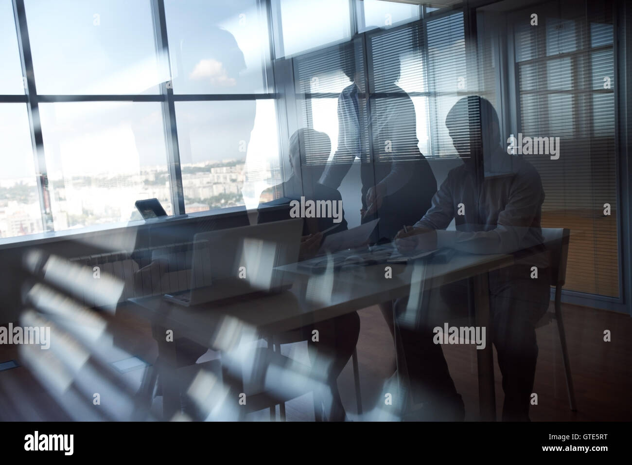 People behind blinds Stock Photo - Alamy